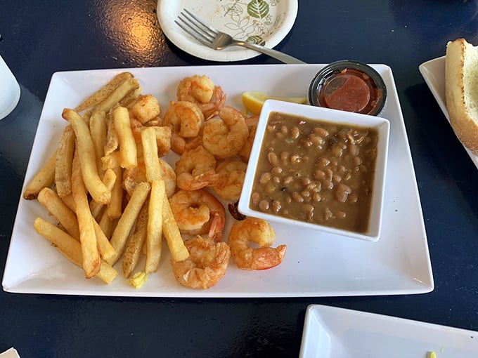 Golden shrimp, crispy fries, and baked beans—the holy trinity of comfort that proves sometimes the simplest combinations make for the most satisfying meals.