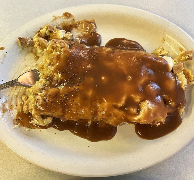 Gravy isn't just a condiment here—it's practically a religion. This open-faced sandwich drowning in savory goodness makes you want to convert immediately.