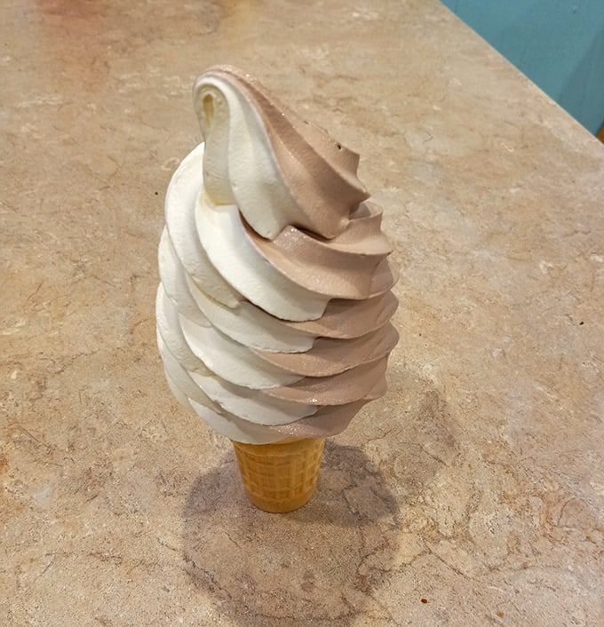 Soft-serve perfection spiraled into a crisp cone – the kind of simple pleasure that makes you forget about fancy desserts altogether.