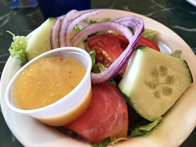 A garden-fresh salad that proves vegetables can be more than just an obligation—they can be a delight, especially with that sunshine-yellow dressing.