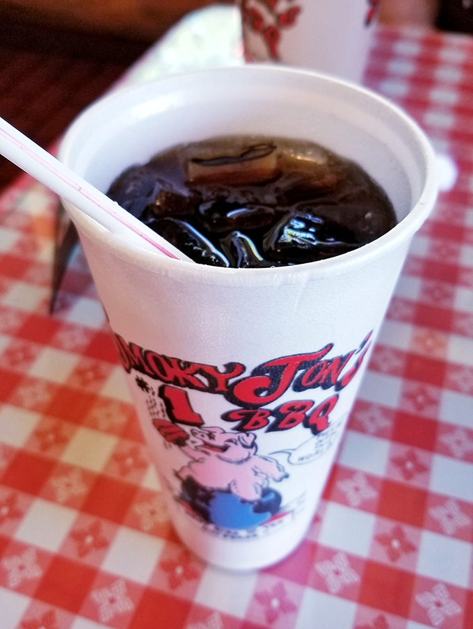 Even the drinks come with personality here – that familiar dark cola providing the perfect sweet counterpoint to all that savory smoke.
