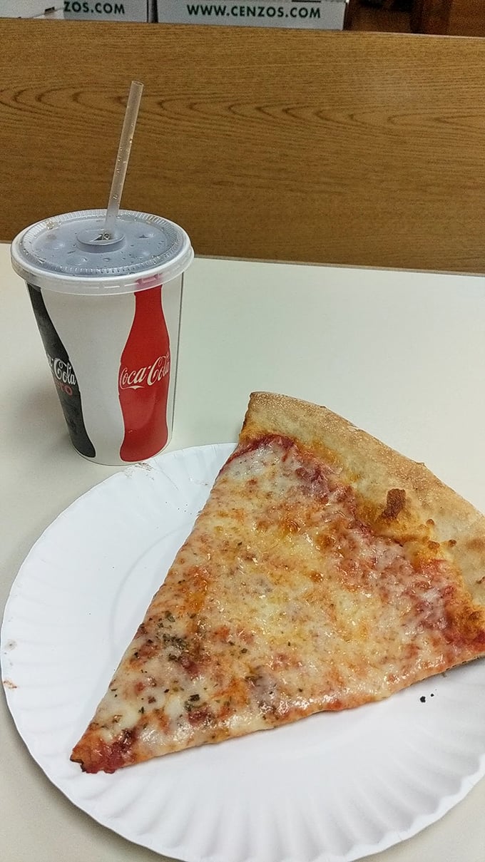 The simple pleasure of a cold soda alongside a slice. Some traditions don't need reinvention, just appreciation.
