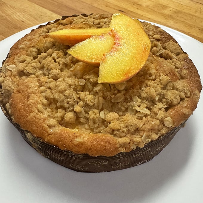 A peach-topped crumb cake that doesn't just whisper "summer"—it belts out a full seasonal anthem with buttery, streusel-topped enthusiasm.