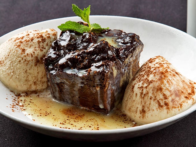 This sticky toffee pudding isn't just dessert—it's an event. Those scoops of ice cream are melting faster than my willpower ever could.