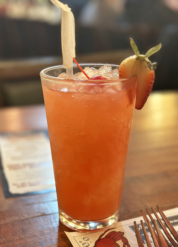 This isn't just a strawberry lemonade – it's summer in a glass, complete with a fruit garnish that's trying to steal the show.