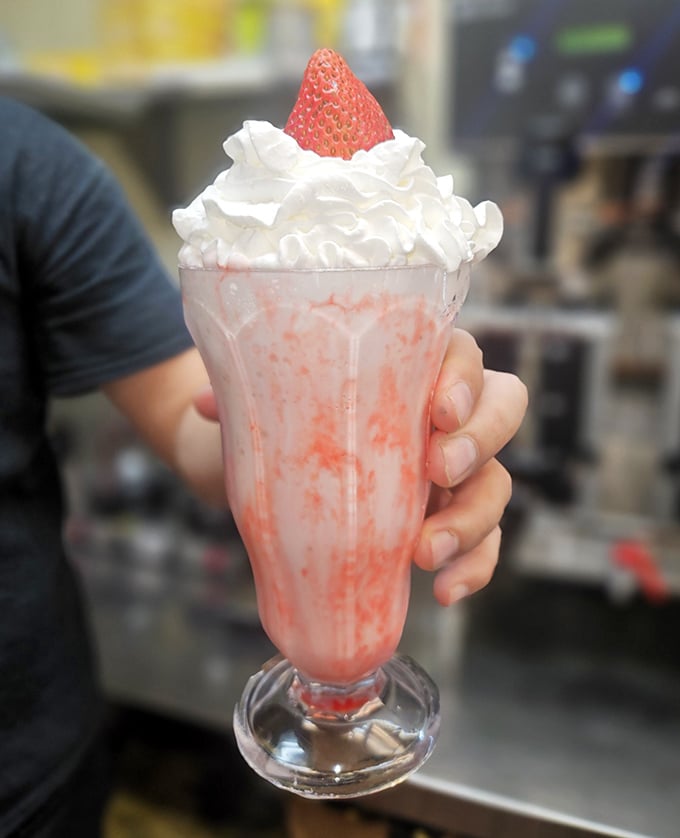 This strawberry milkshake isn't just a drink—it's a dessert, a work of art, and a childhood memory all swirled into one glorious glass.