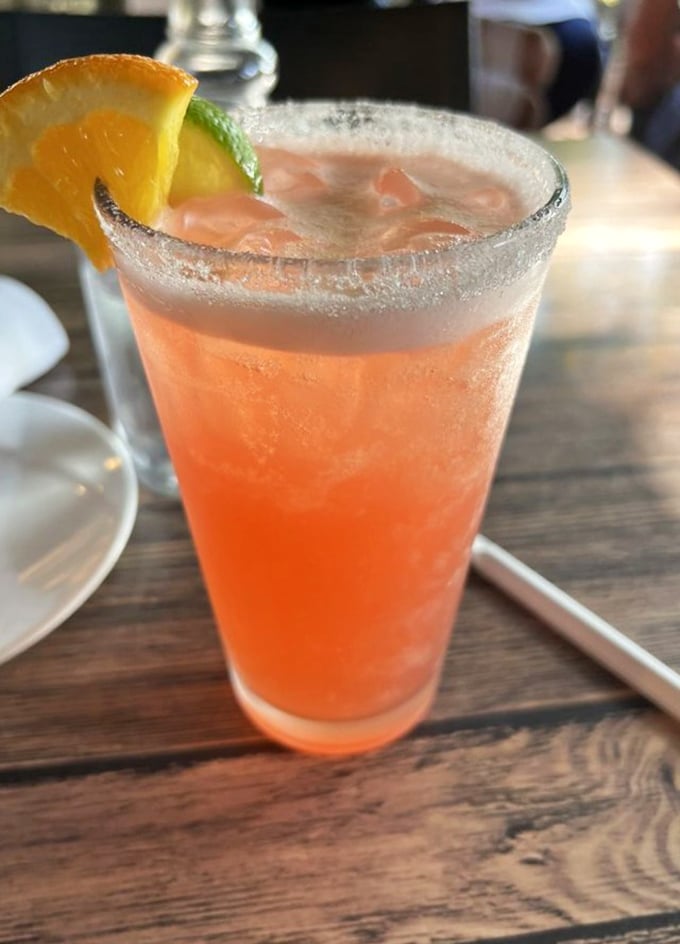 This peachy-pink cocktail isn't just a drink, it's a vacation in a glass—complete with a sugar rim "beach" and citrus "sunshine."