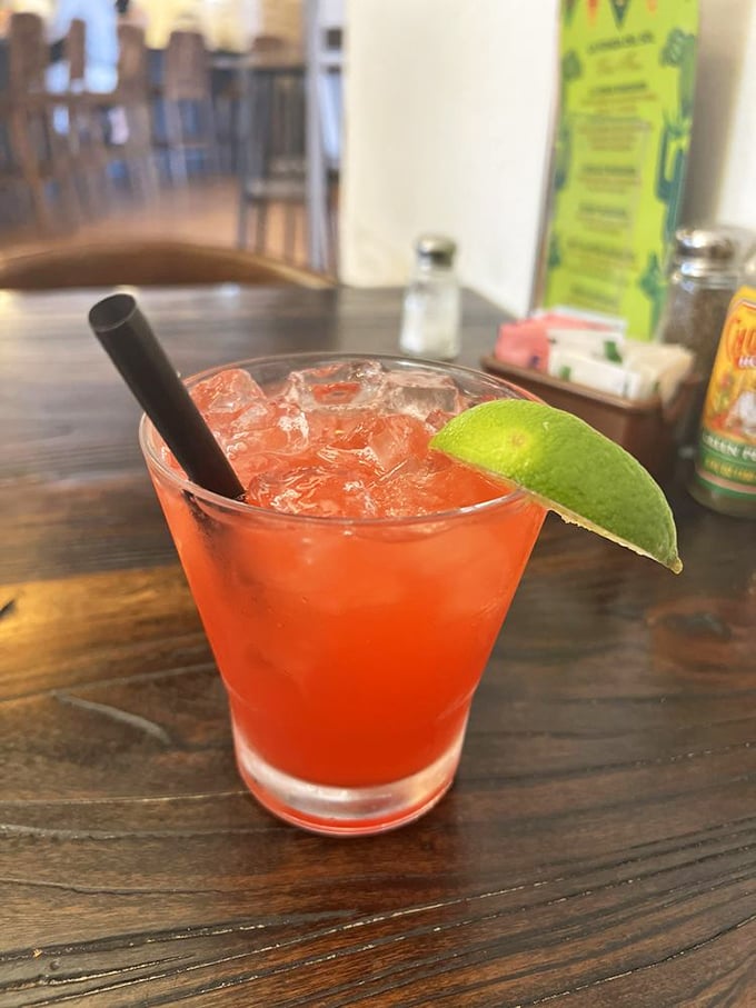 The strawberry margarita—where fruit meets tequila in a vacation-worthy glass. That lime wedge isn't just garnish; it's an exclamation point.
