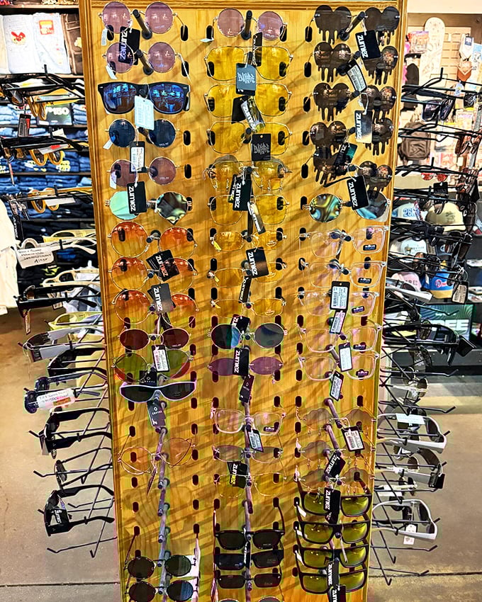 Sunglasses display that rivals a Vegas buffet—overwhelming choices where you'll try on twelve pairs before finding your perfect match.