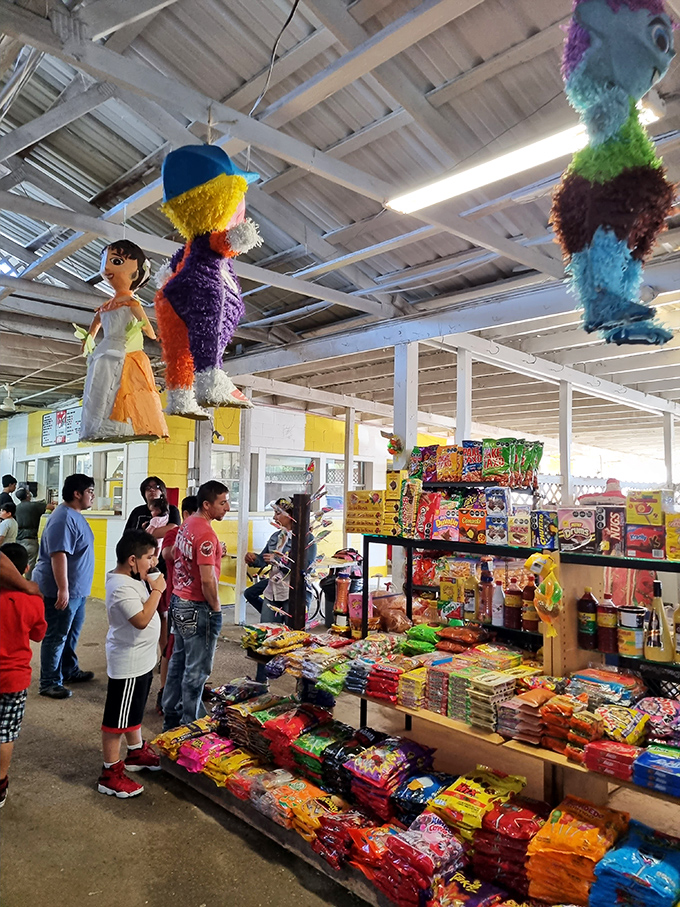 Piñatas watch from above as a candy kingdom unfolds below. This sugar-coated corner would make Willy Wonka himself stop and stare.