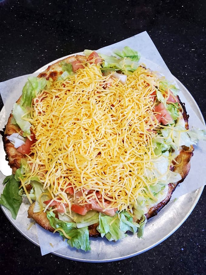 The taco pizza isn't just fusion food—it's a fiesta on flatbread, where lettuce, tomato, and shredded cheese create a colorful Mexican-Italian alliance.