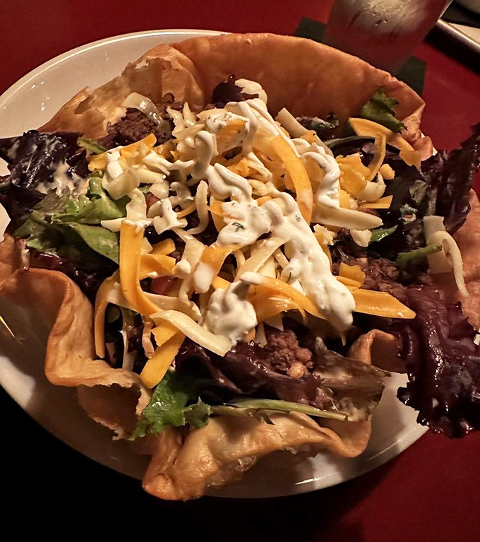 This taco salad bowl doesn't know the meaning of "modest portion"—it's a crunchy, cheese-topped celebration of Midwest generosity in edible form.