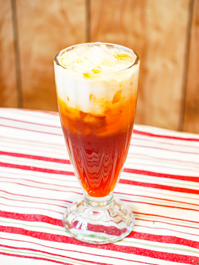 The Thai Iced Tea – a sweet, creamy amber elixir that cools the palate between spicy bites – is practically mandatory with any meal here.