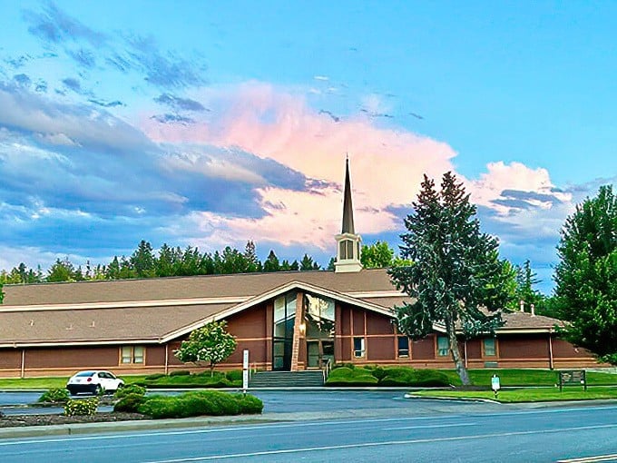 Faith finds architectural expression against perfect blue skies. Sunday best meets everyday spirituality in structures that anchor the community.