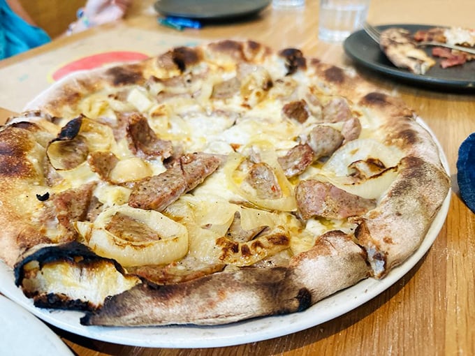 The Wise Guy pizza lives up to its name—smartly combining wood-roasted onions, fennel sausage, and smoked mozzarella into pure genius.