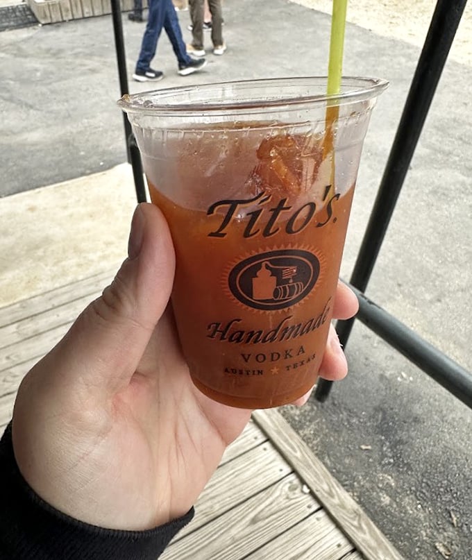 Sweet tea in a Tito's cup – the unofficial state beverage of Texas, perfect for cutting through the richness of world-class barbecue.