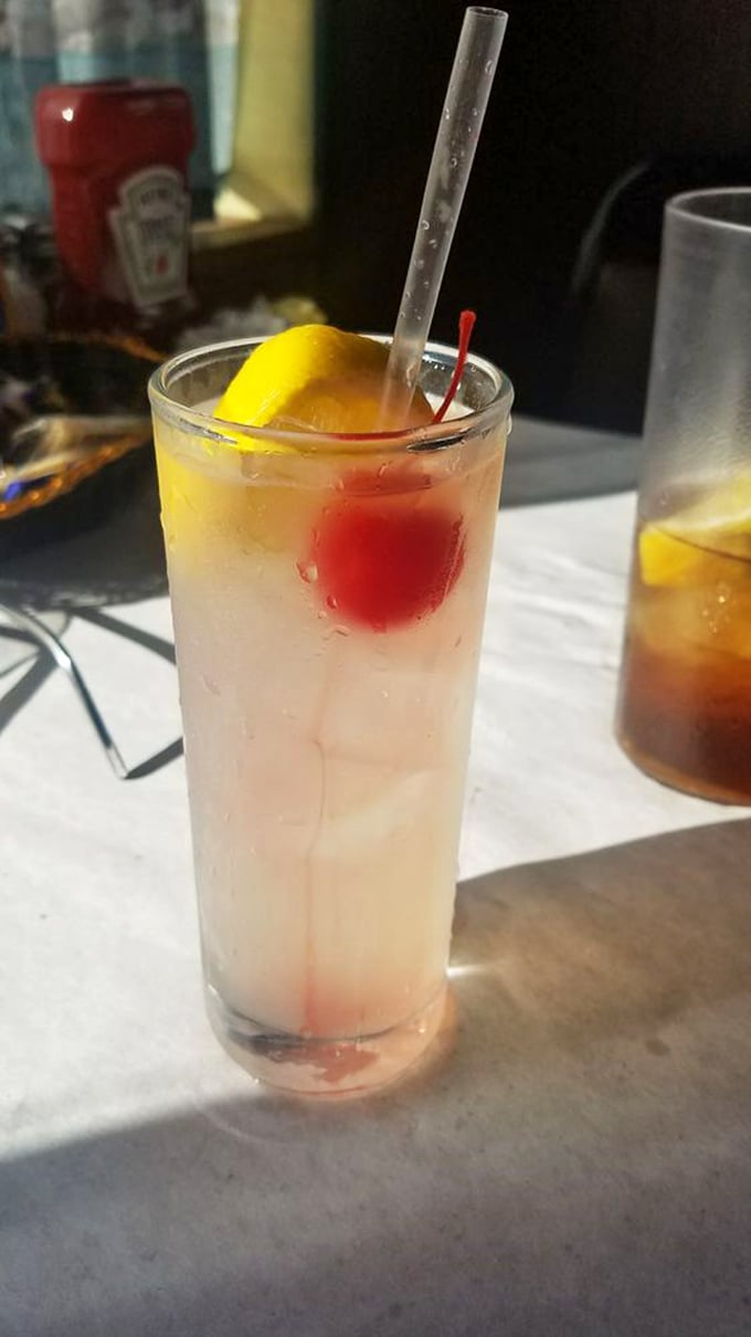 That's not just a Tom Collins—it's vacation in a glass, complete with the cherry and lemon that say "you deserve this moment."
