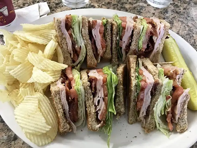 The club sandwich—architecture you can eat. These layers deserve their own blueprint, with each story more delicious than the last.
