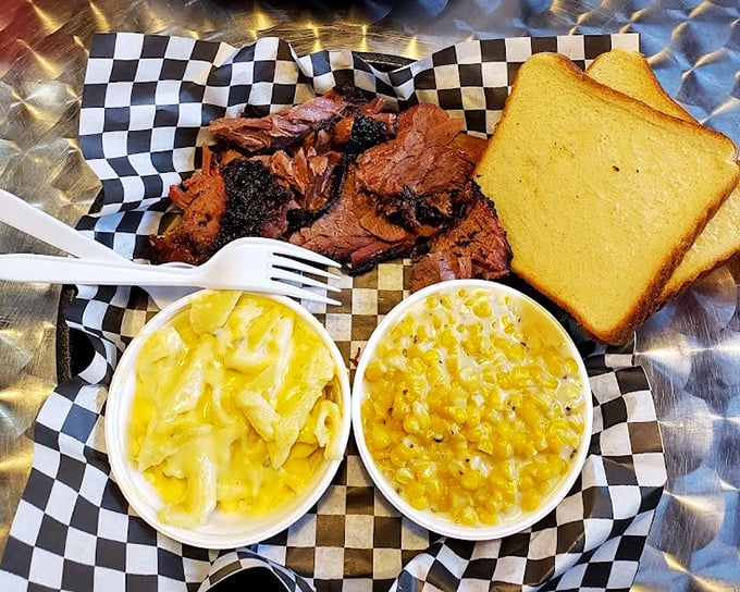 The two-meat plate with mac and corn – a trilogy more satisfying than most Hollywood franchises. Yellow sides frame the smoky star.