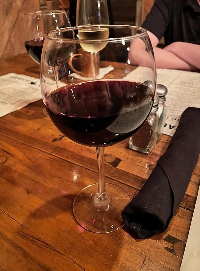A glass of California red, waiting patiently to complement your steak. Wine and beef—a romance as old as time.