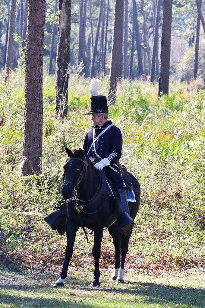 Time-traveling cavalry: A reenactor in period-perfect uniform patrols the battlefield, his serious expression reflecting the gravity of history he represents.