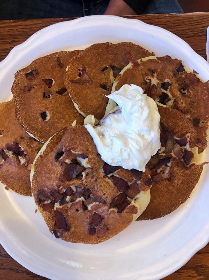 Chocolate chip pancakes topped with a cloud of whipped cream – breakfast masquerading as dessert, and nobody's complaining.