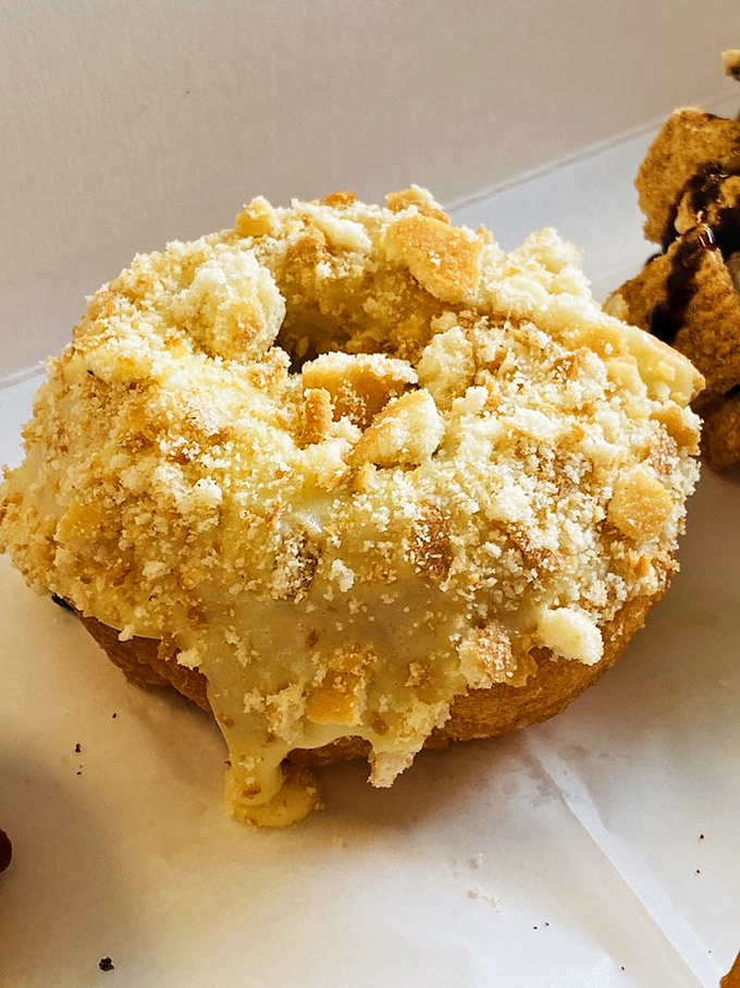 The crumb-topped banana donut doesn't just sit there looking pretty – it practically whispers "forget your diet" with every golden crumb.