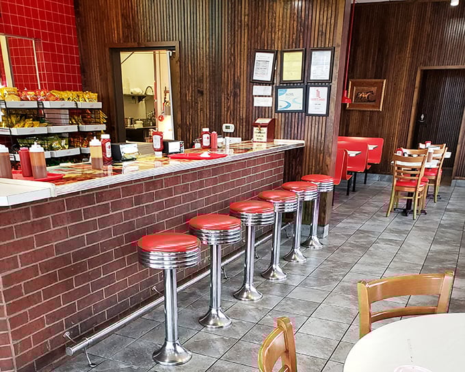 Classic diner counter seating where barbecue dreams come true. Those red stools aren't just places to sit—they're front-row seats to culinary theater.