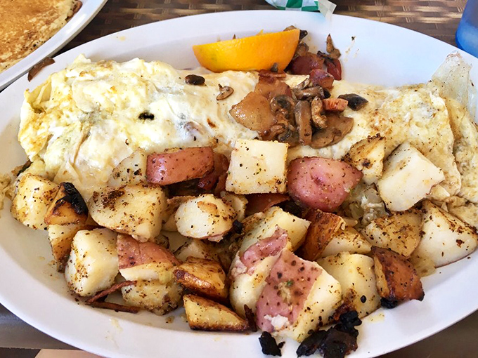 Potatoes roasted to crispy-outside, tender-inside perfection alongside eggs – proof that simple ingredients become extraordinary in the right hands.