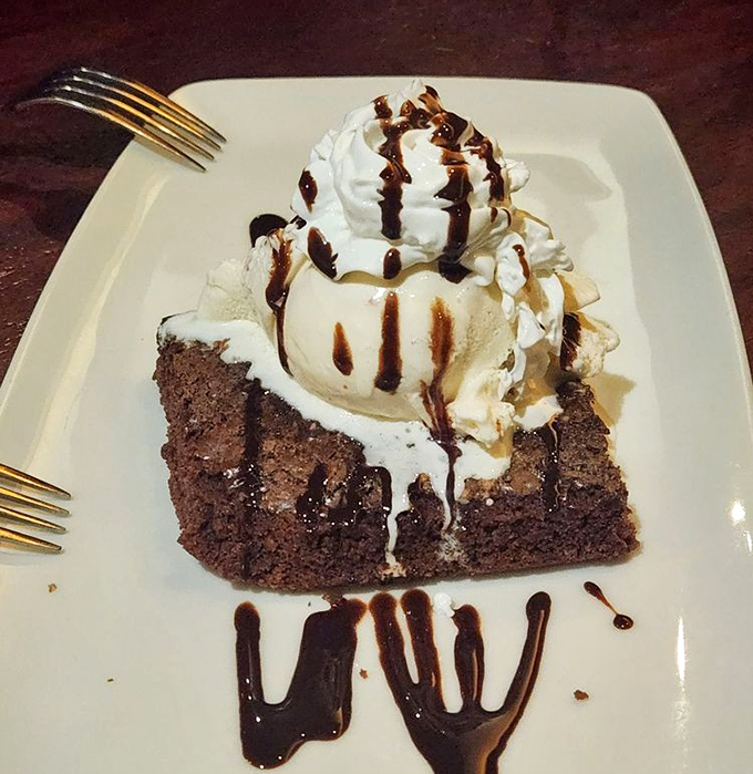 A brownie topped with spumoni ice cream—where chocolate meets Italian frozen magic in a dessert liaison that would make your cardiologist wince and your taste buds sing.