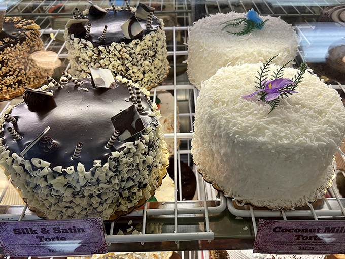 The cake display showcases edible artwork that's almost too beautiful to eat – almost being the key word here.