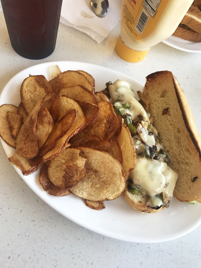 This sandwich isn't just a meal—it's an engineering marvel of melted cheese, tender filling, and house-made chips that crunch loud enough to turn heads.