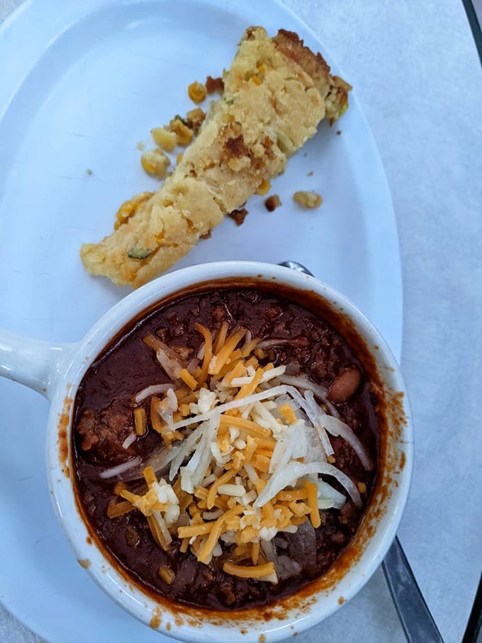 Hearty chili topped with melted cheese and a side of cornbread—desert comfort food that warms you from the inside out.