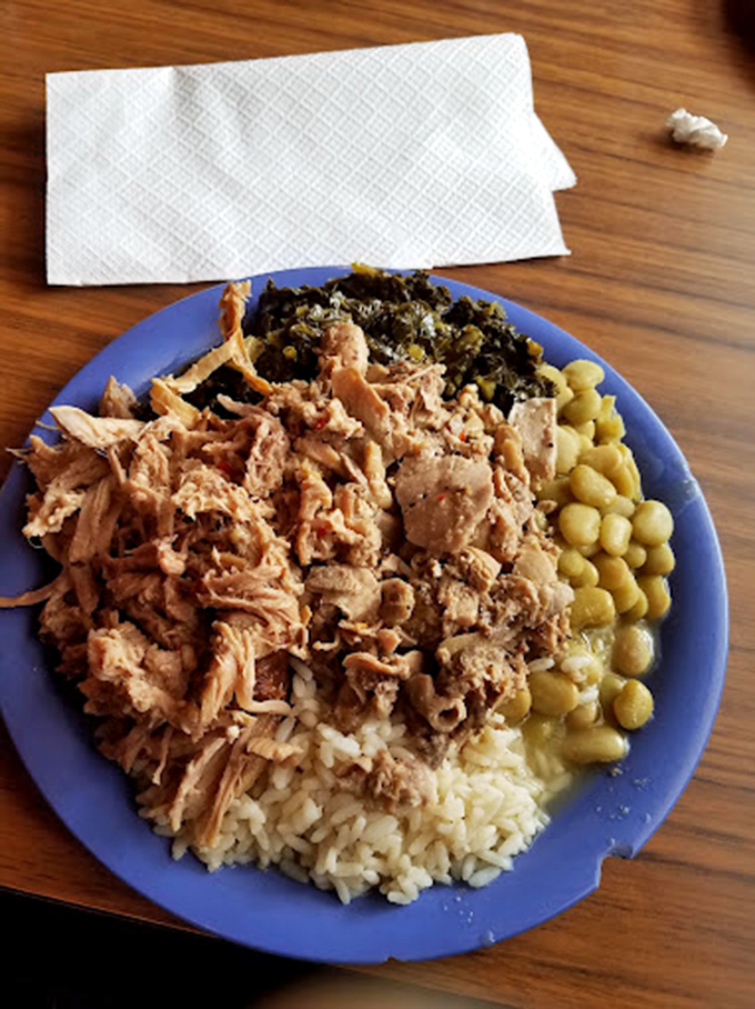 A blue plate special featuring pulled pork, collards, and field peas over rice – the holy trinity of Southern cuisine.