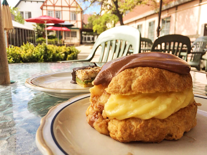 This chocolate-topped cream puff isn't just dessert—it's therapy in pastry form, with a custard filling that could solve international conflicts.