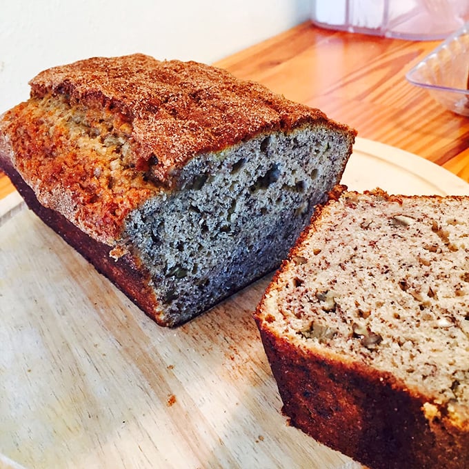 Banana bread elevated to art form—moist, cinnamon-speckled, and sliced to reveal its tender crumb interior.