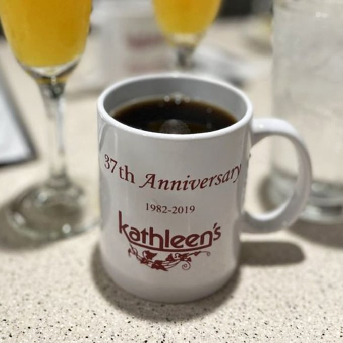 Coffee served in a commemorative mug that tells you this place has history—and knows how to brew a cup worth celebrating.