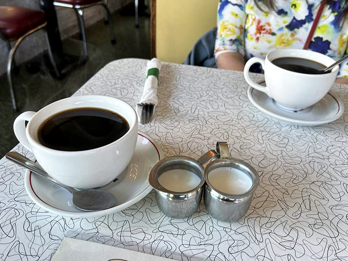 Coffee served in those iconic thick white mugs—the kind that keep your beverage hot and your conversation flowing.