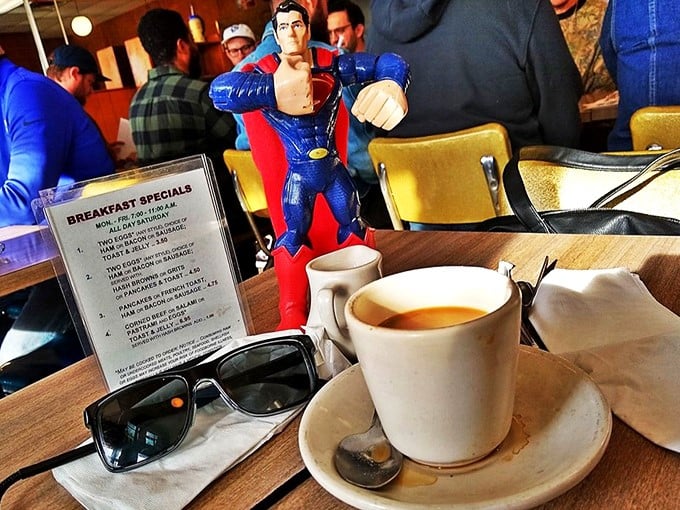 Coffee, sunglasses, and Superman standing guard over your breakfast—because even superheroes know Hygrade's morning menu is worth protecting.