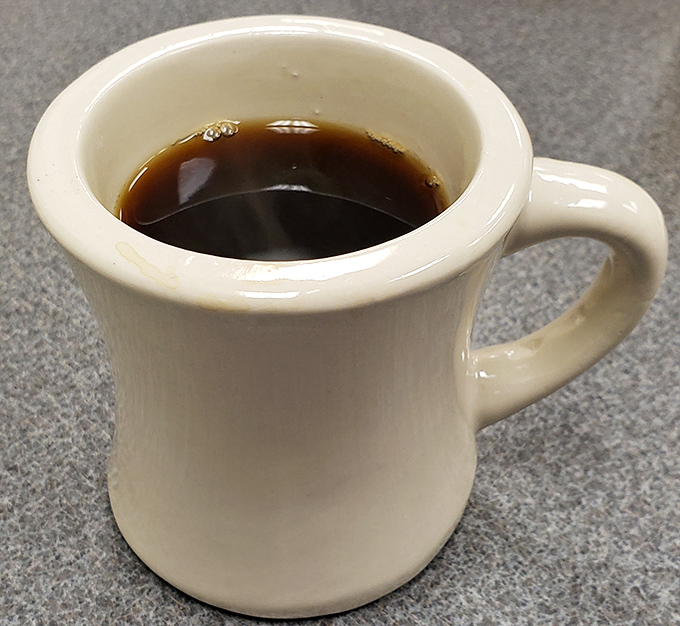 The humble diner coffee mug – sturdy, unpretentious, and filled with liquid motivation. This isn't fancy coffee; it's necessary coffee.