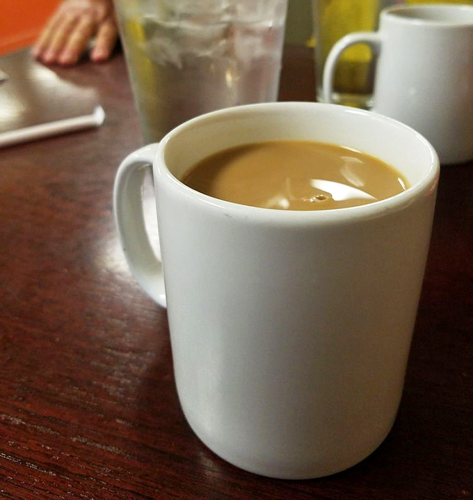 The humble white mug—civilization's perfect delivery system for life-giving coffee. At Ray's, refills appear like magic, keeping breakfast dreams alive.
