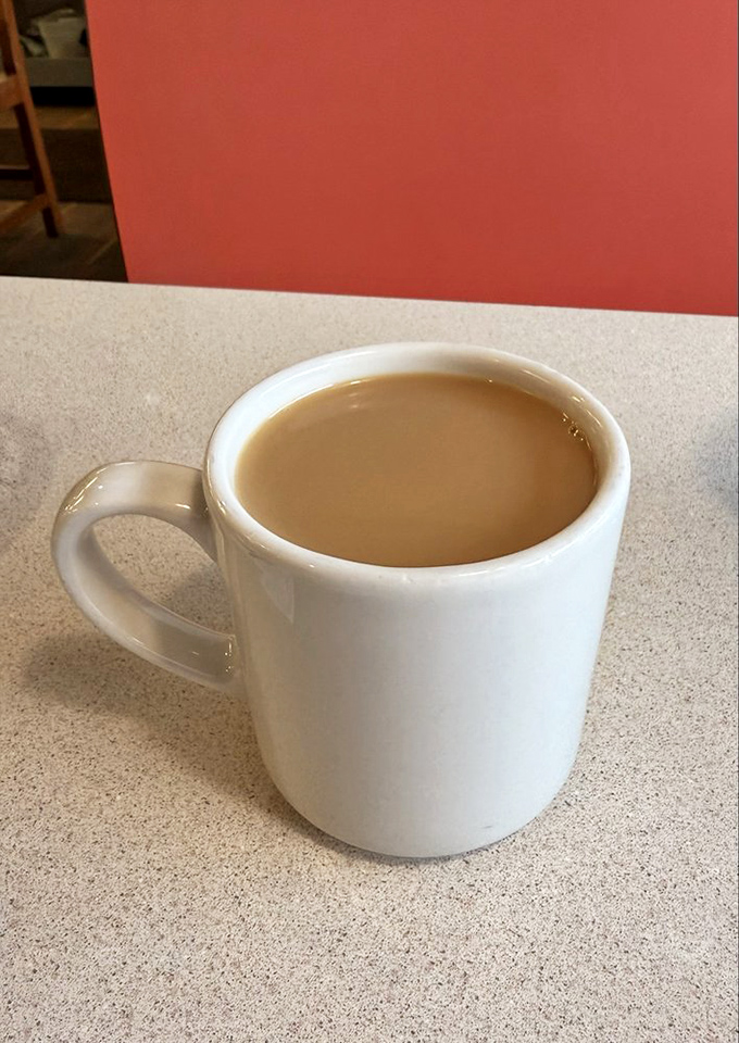The humble diner coffee mug—holding what might be the most honest beverage in America. No foam art, no pretension, just caffeine and comfort.