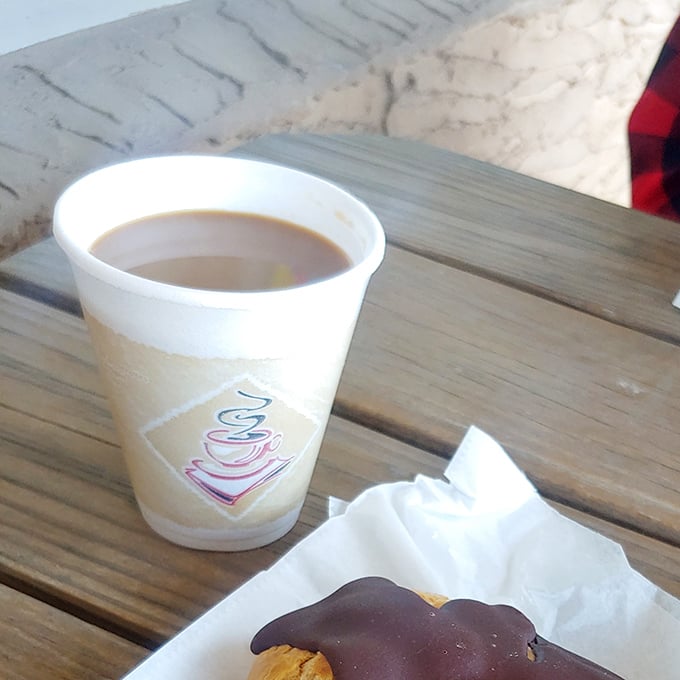 A simple cup of coffee and a chocolate-dipped treat—proof that sometimes life's greatest pleasures come in humble packages.