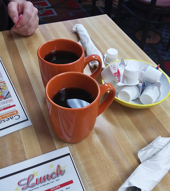 Those bright orange coffee mugs aren't just containers; they're promises of refills, conversation, and the fuel that powers Bradenton's morning rituals.