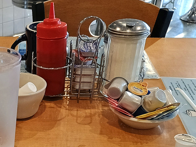 The holy trinity of diner condiments: ketchup, sugar, and salt – simple tools that transform good food into personal perfection. 