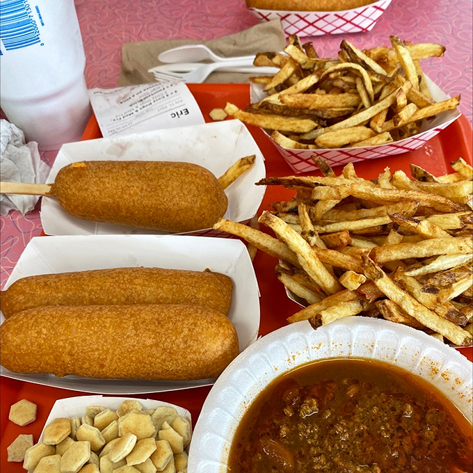 The perfect road trip fuel – two Cozy Dogs and a mountain of fries that would make any cardiologist nervously update their contact information.