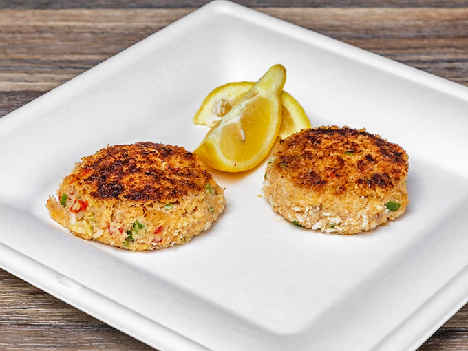 These golden-brown crab cakes aren't just appetizers—they're little discs of oceanic joy that deserve their own fan club.