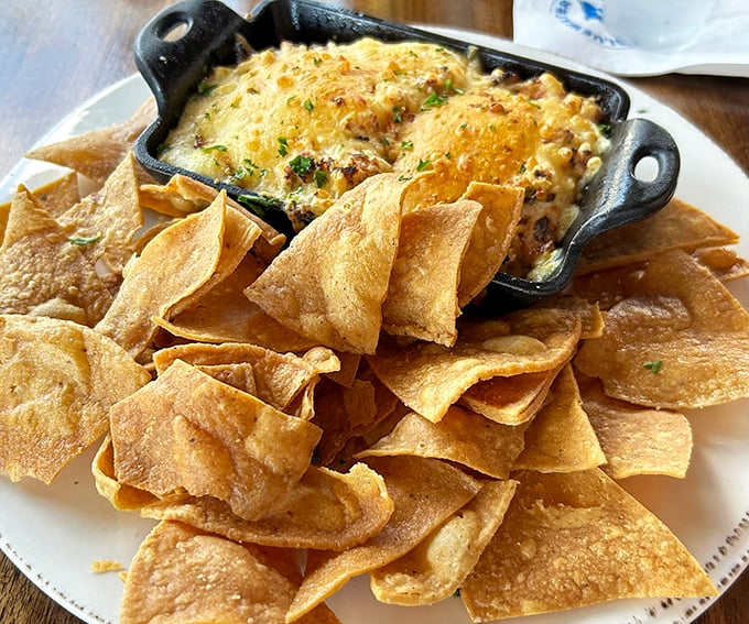 This crab and artichoke dip isn't just an appetizer—it's the opening act that threatens to upstage the headliner. Those chips are merely vehicles for greatness.