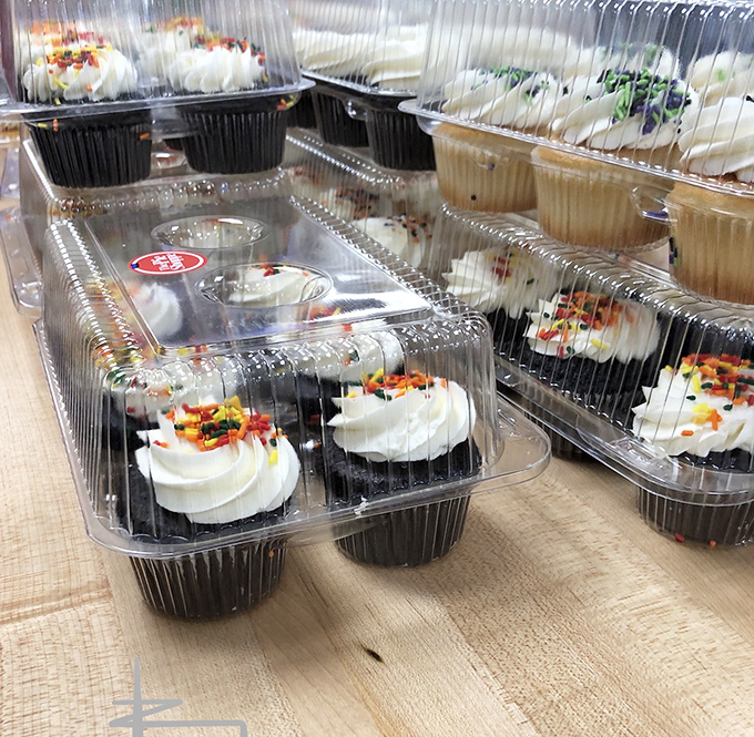 Cupcakes lined up like tiny edible works of art, each one promising a perfect ratio of frosting to cake—the mathematical equation of happiness.