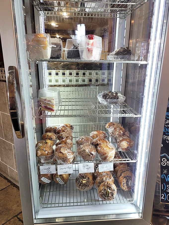 The dessert case—where willpower goes to die. Those muffins are practically whispering your name from behind the glass.
